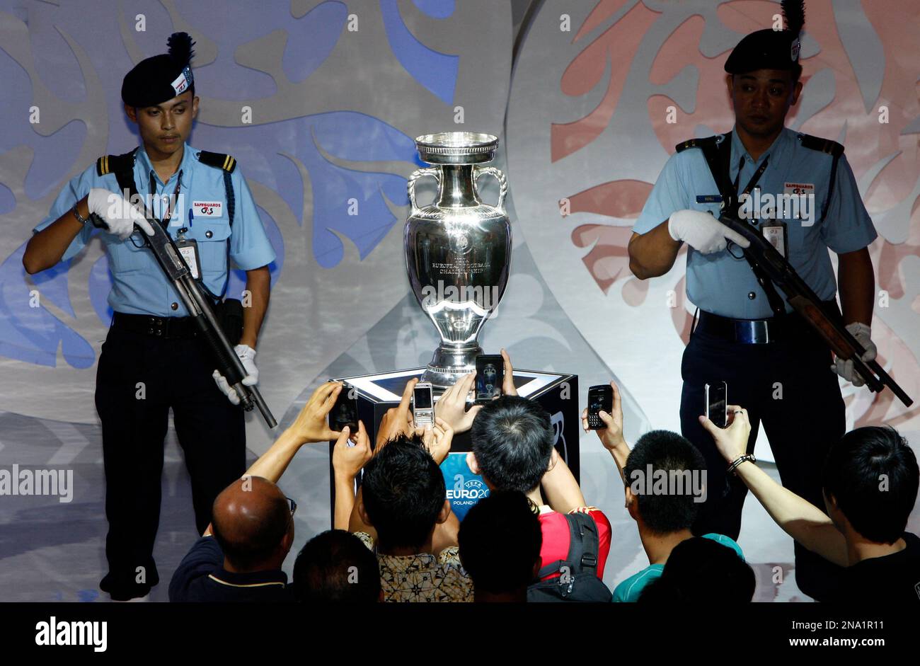 Soccer fans take photos of the UEFA Euro 2012 trophy during its tour in ...
