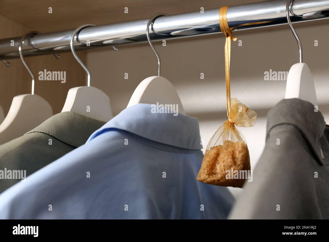 Scented sachet and clothes hanging in wardrobe Stock Photo - Alamy