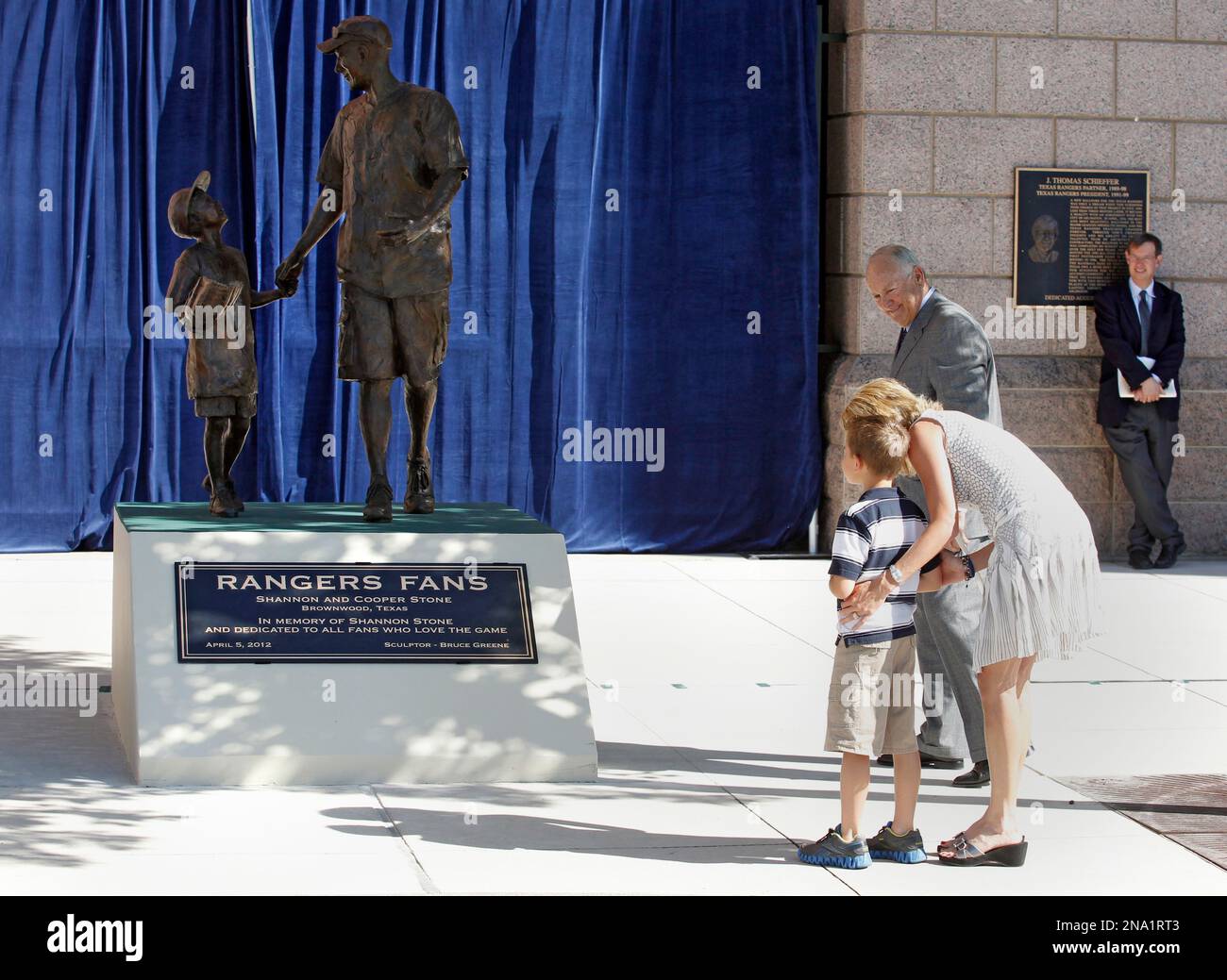Cooper Stone, 7, hugs his mother, Jenny Stone, as Texas Rangers owner ...