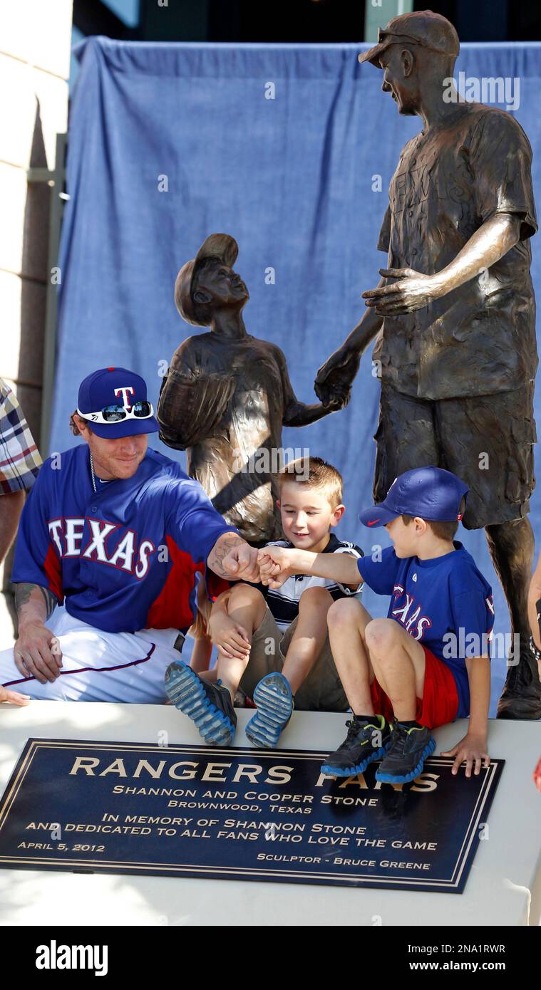 Texas Rangers' Josh Hamilton sits with Cooper Stone, 7, and his friend ...