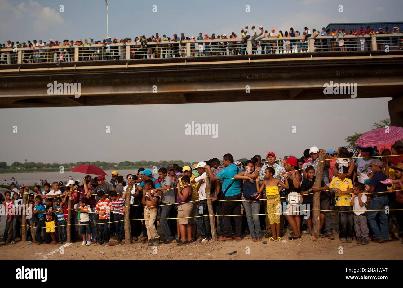 In this photo March 31, 2012 photo, people watch horse races across the ...