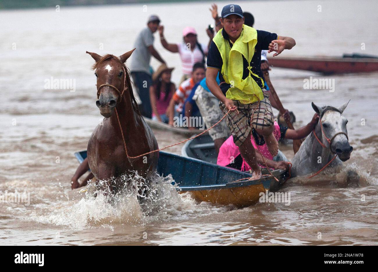 In this March 31, 2012 photo, a man jumps off his canoe to run for the ...