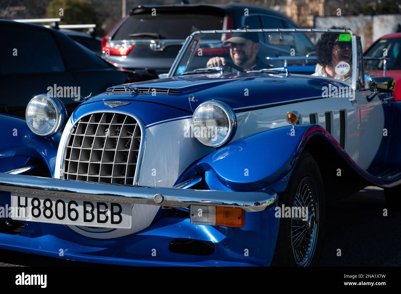 A man and woman in an old blue Panther Lima sports car in Barcelona ...