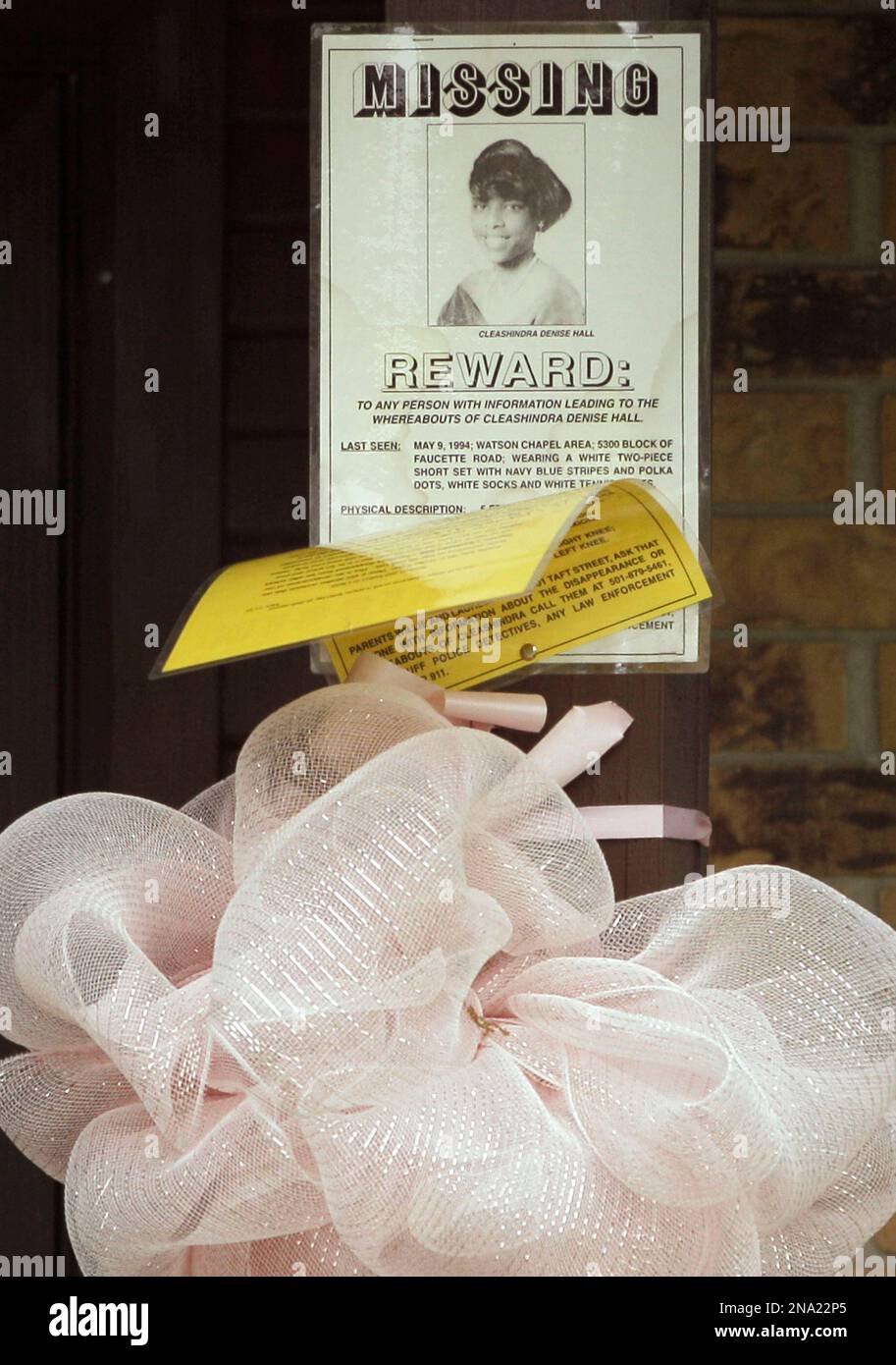 A missing person poster and ribbon are attached to a post on the front ...