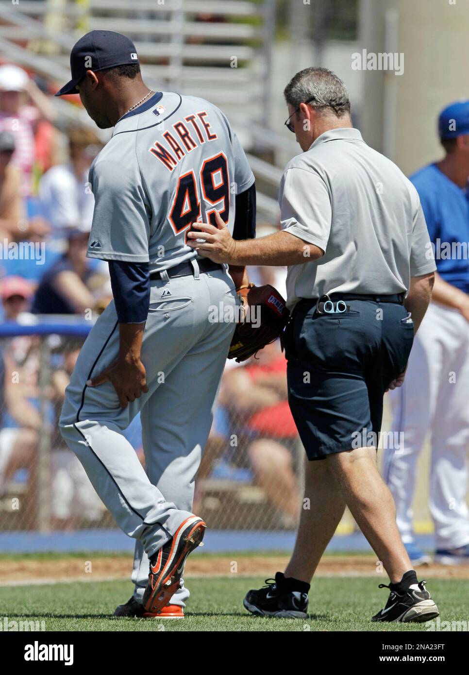 Detroit Tigers head trainer Kevin Rand escorts relief pitcher Luis ...