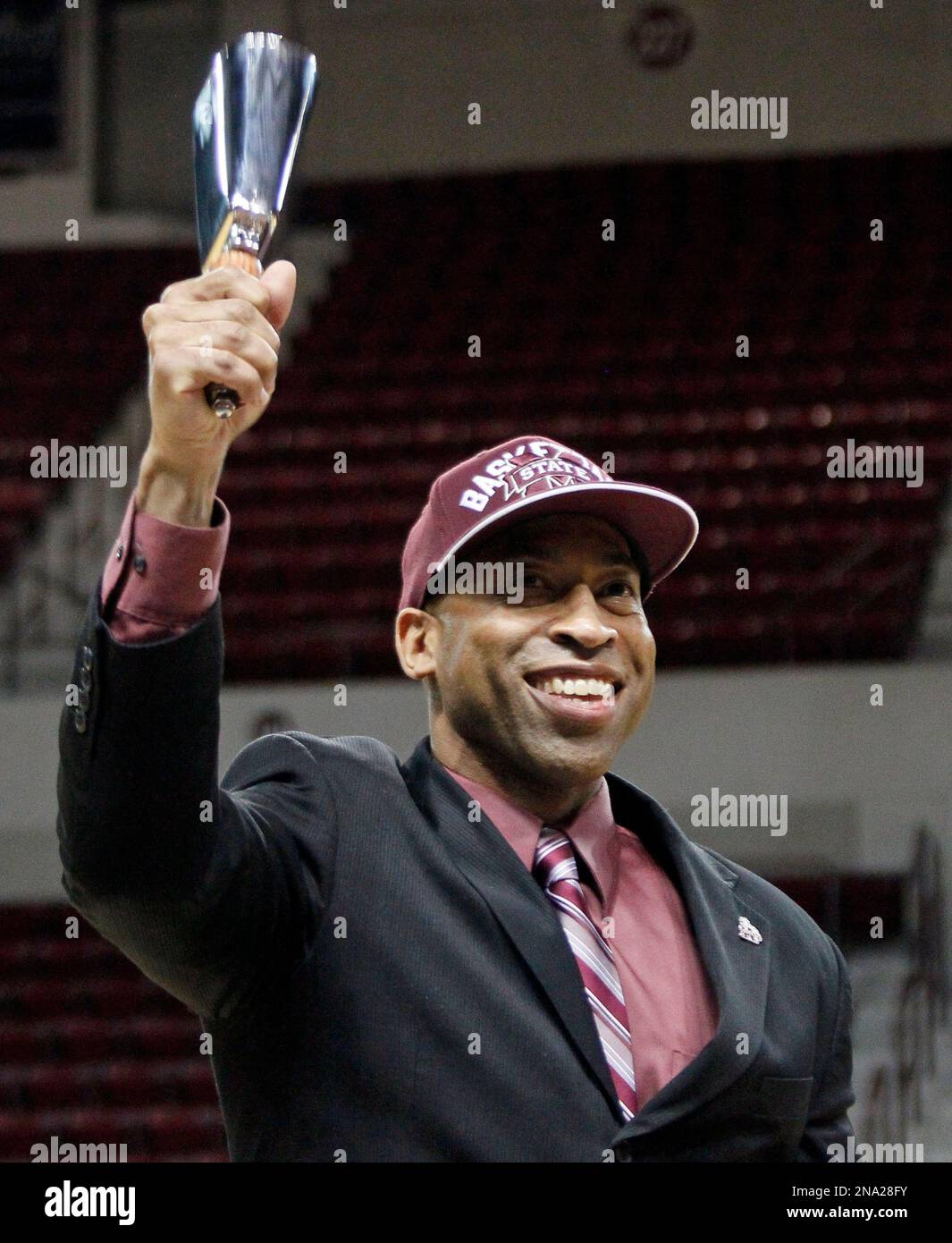 Rick Ray waves a cowbell after being introduced as Mississippi State’s ...