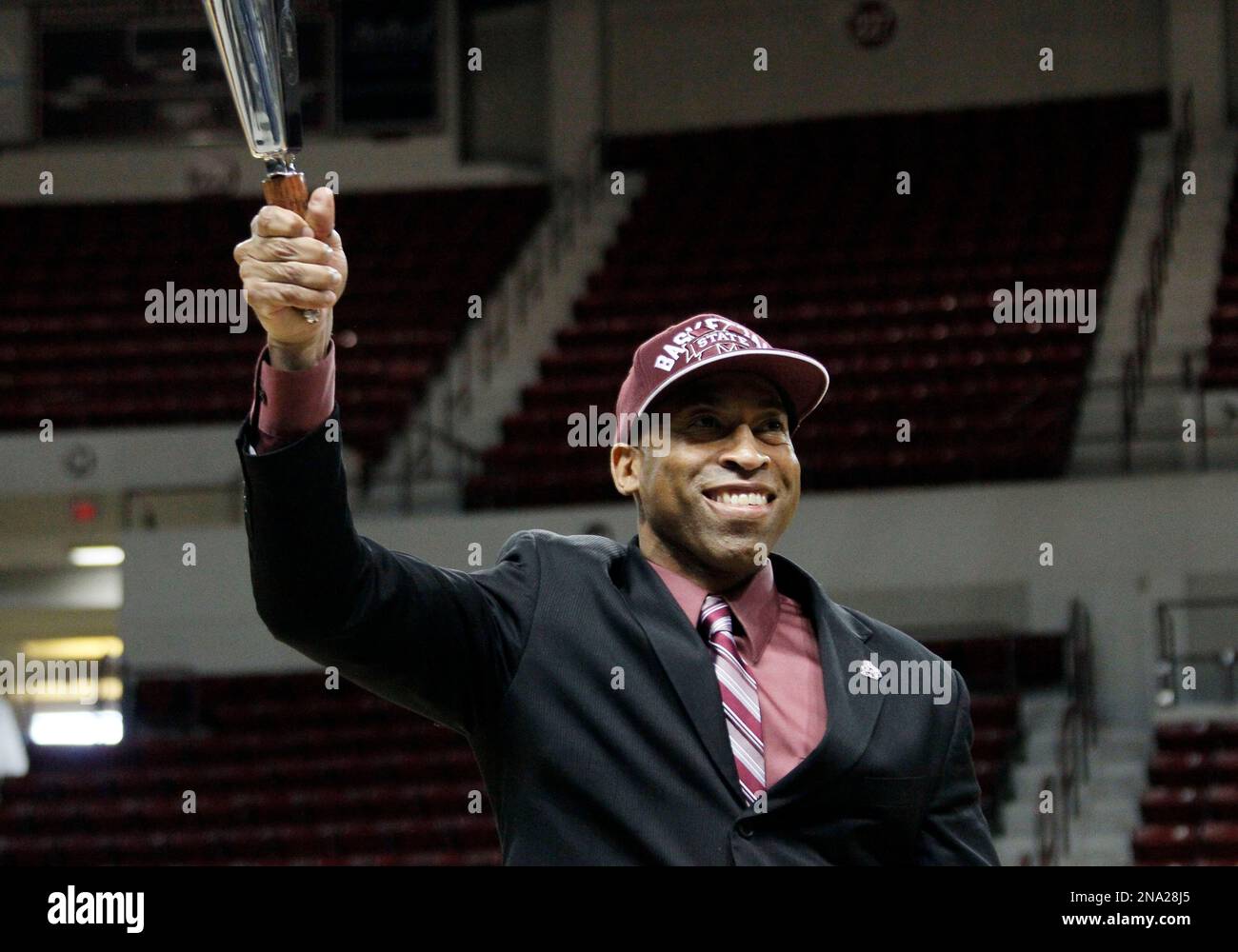 Rick Ray waves a cowbell after being introduced as Mississippi State’s ...