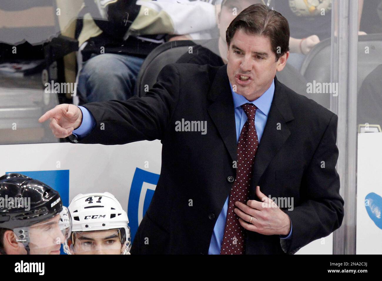 Philadelphia Flyers coach Peter Laviolette talks with a linesman during ...