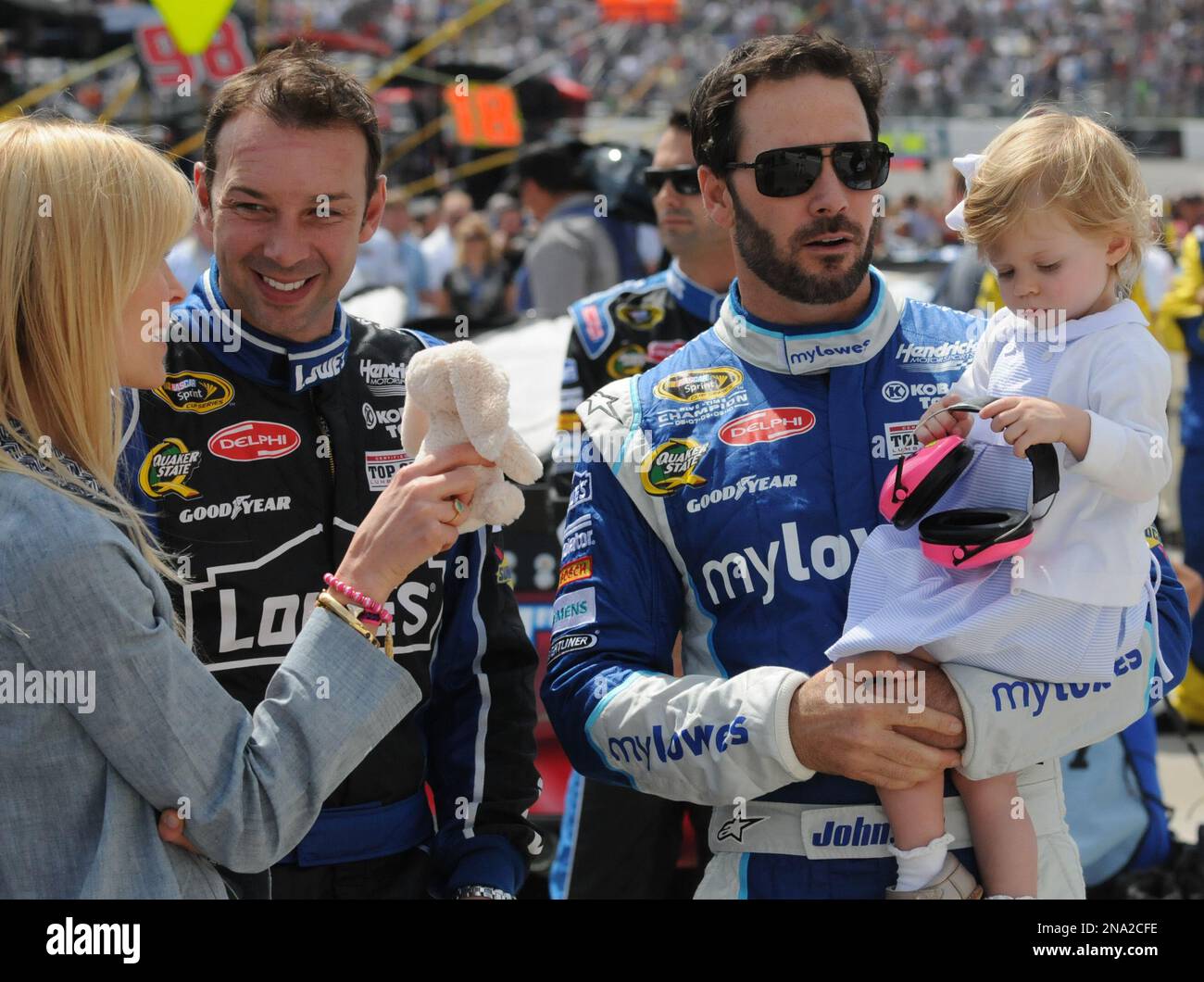 Jimmie Johnson Holds His Daughter Genevieve As He Stands With His