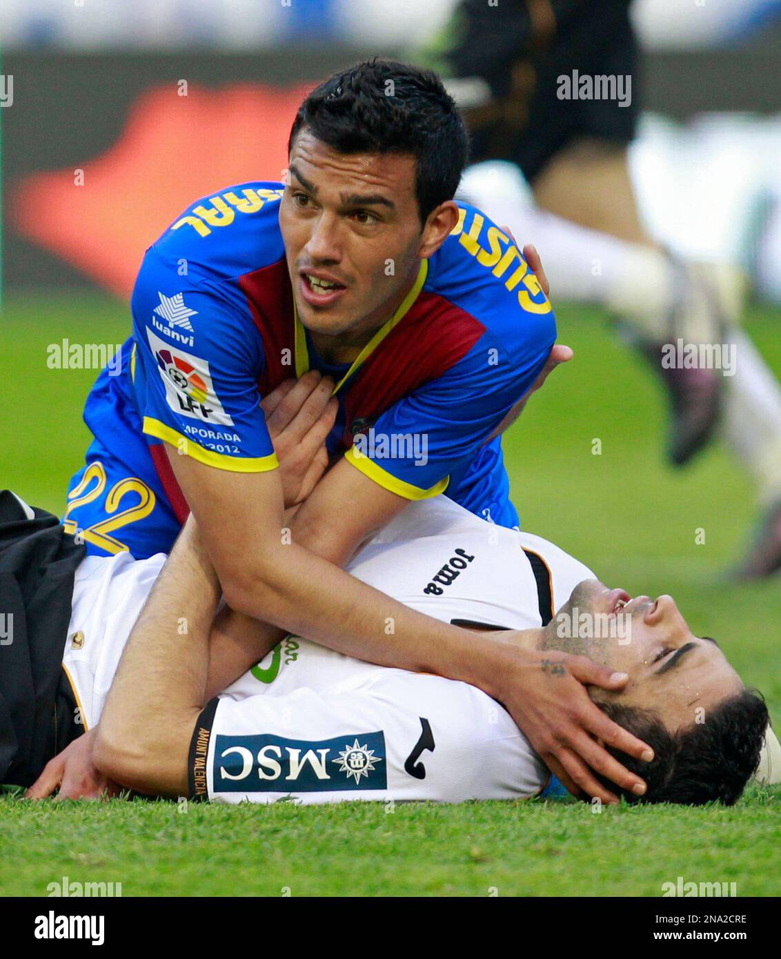 Levante's Gustavo Cabral, top, and Valencia's Adil Rami from France ...