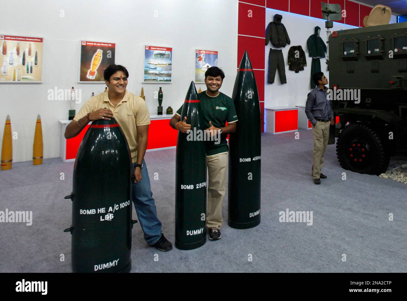 Visitors pose with "dummy" bombs manufactured by India's Ordnance ...