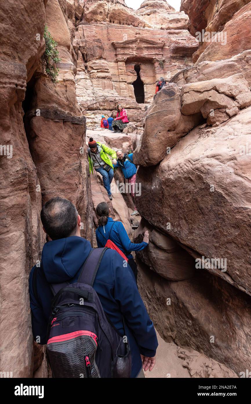 Petra, Jordan. 30th Jan, 2023. Tourists walk through narrow paths in ...