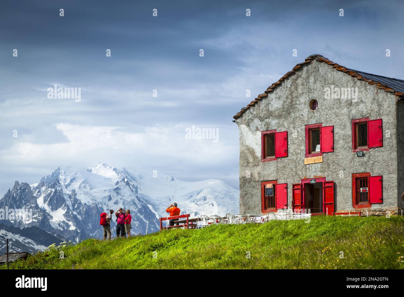 Hikers looking at Mount Blanc from Refuge du Col de Balme at the Swiss ...