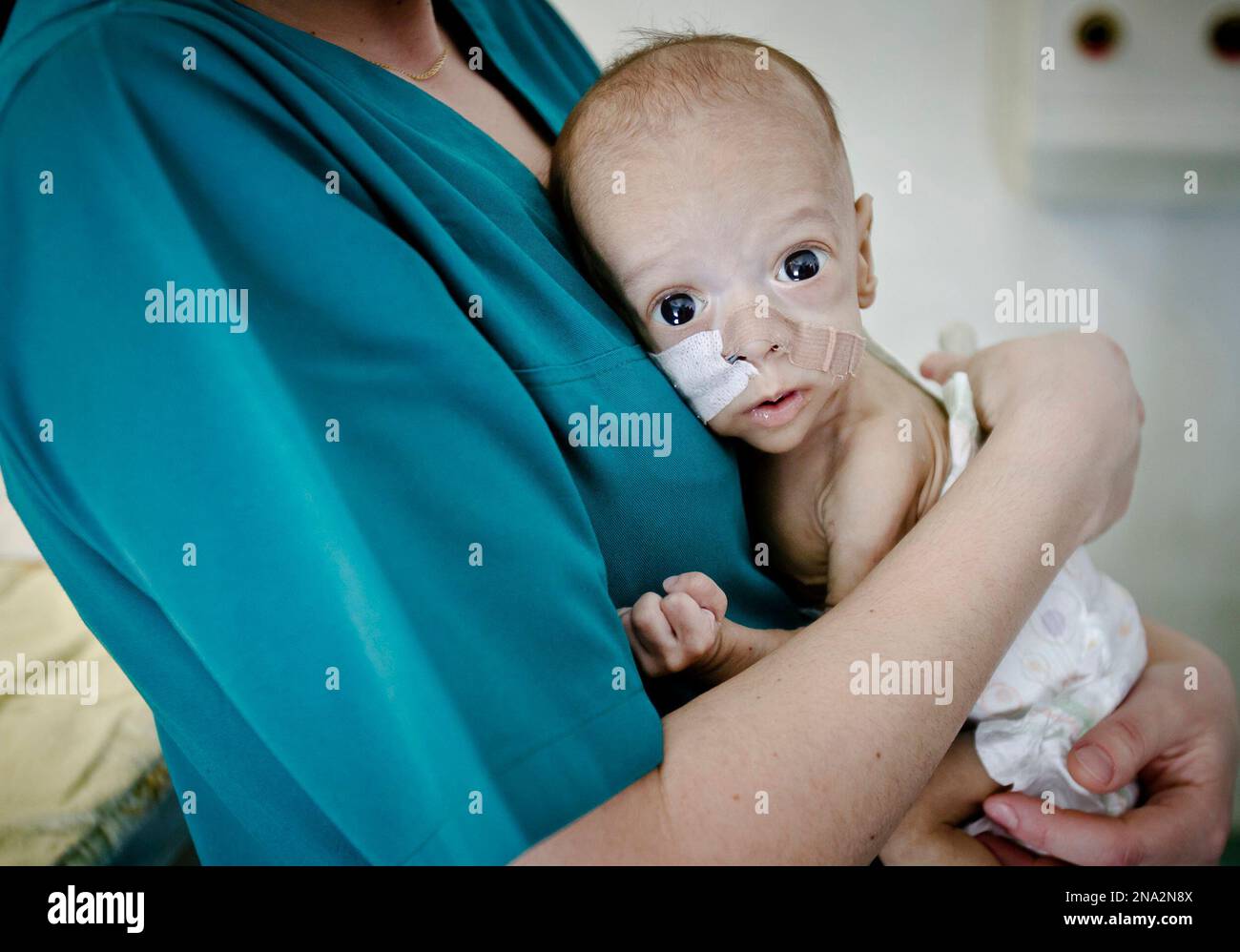 Baby Andrei, eight-month-old, son of Roma underage parents clenches his ...