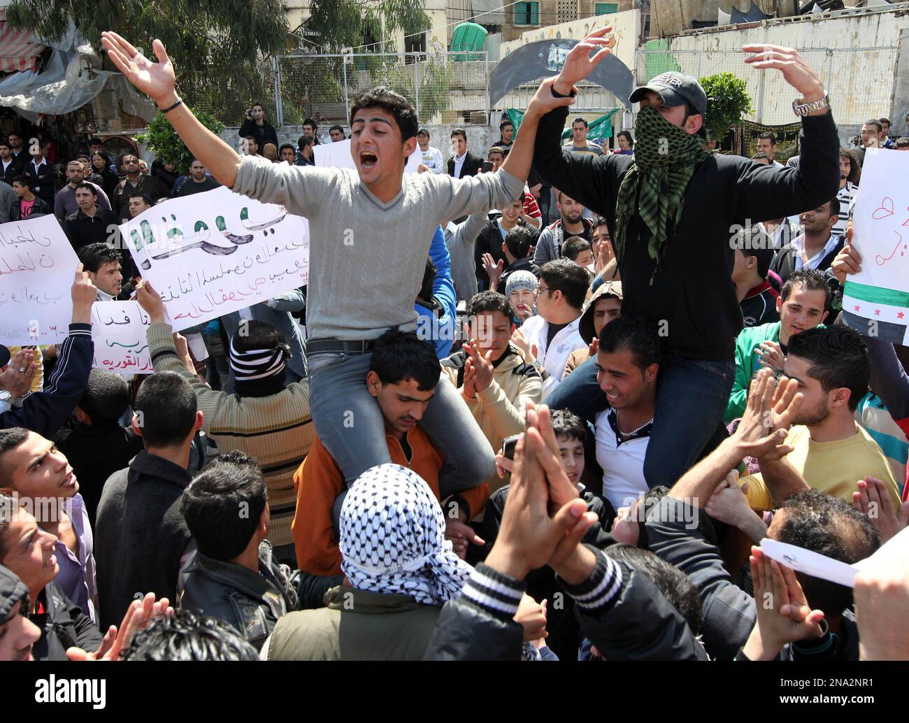 Anti-Syrian regime protesters chant slogans against Syrian President ...