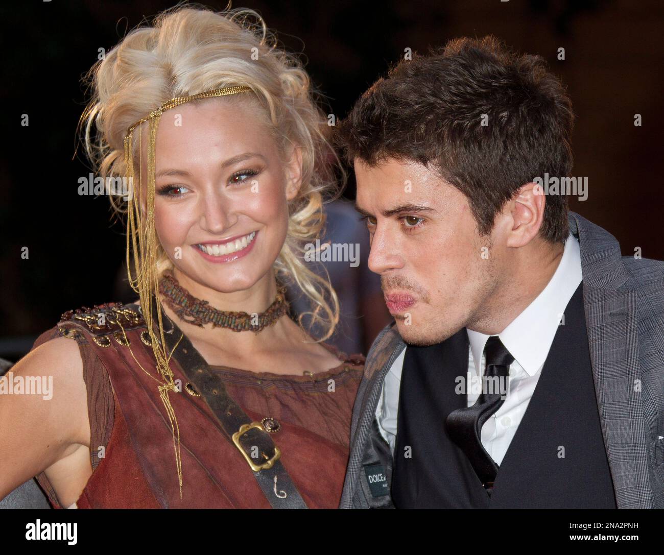 Actor Toby Kebbell poses with a woman in gladiatorial costume as he ...