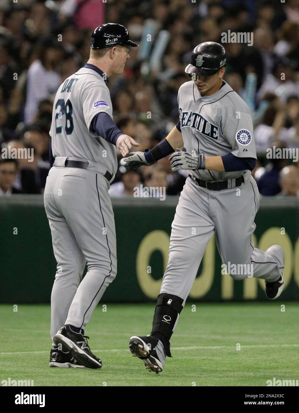 Seattle Mariners' Justin Smoak celebrates with third base coach Jeff ...