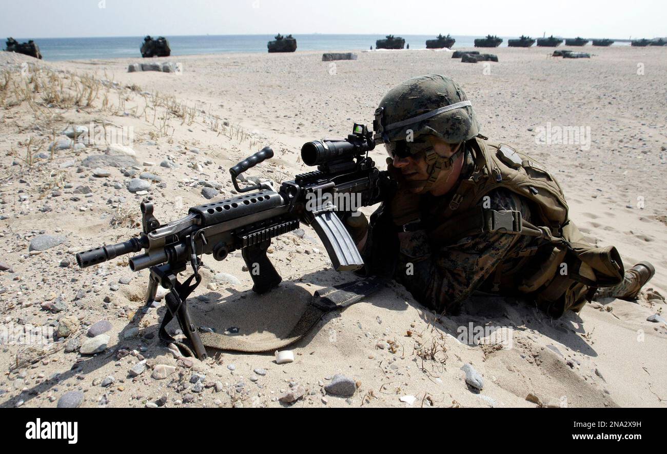 A U.S. Marine aimd his machine gun as U.S. Marine's amphibious assault ...