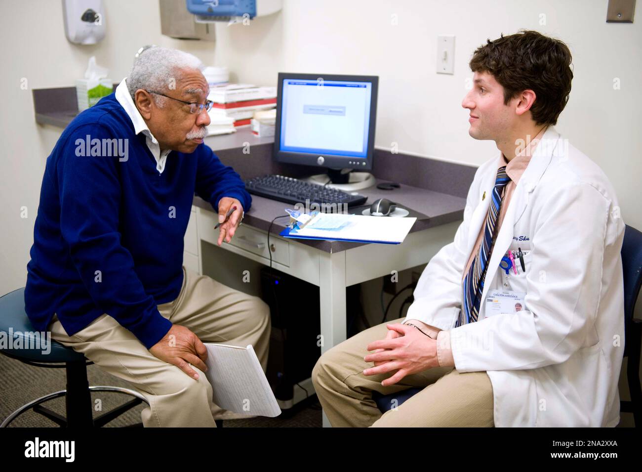 John Askew, Sr., a patient/actor, left gives feedback to third-year ...
