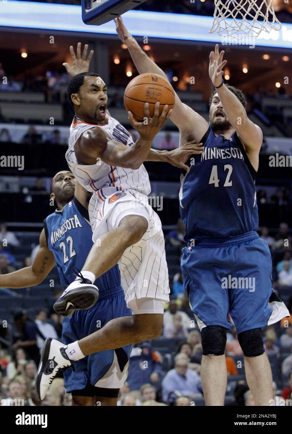 Charlotte Bobcats' Gerald Henderson, center, drives between Minnesota ...