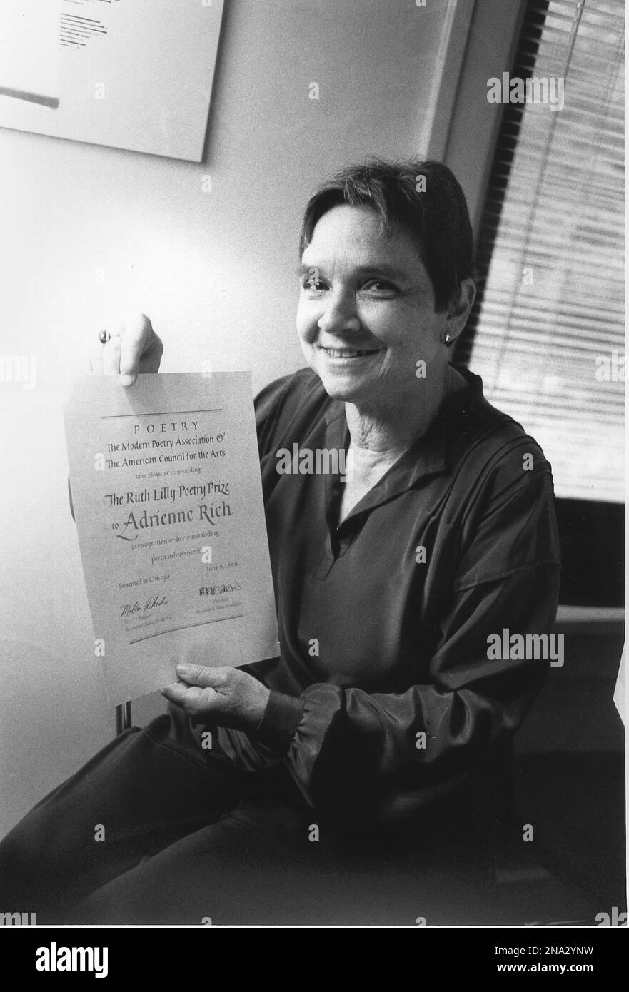 FILE - In this June 6, 1986 file photo, poet Adrienne Rich holds her ...