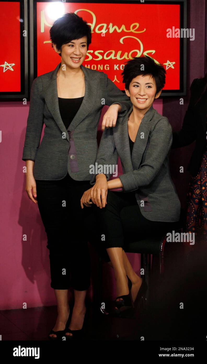 Award winning Hong Kong actress Sandra Ng, left, poses with her wax ...