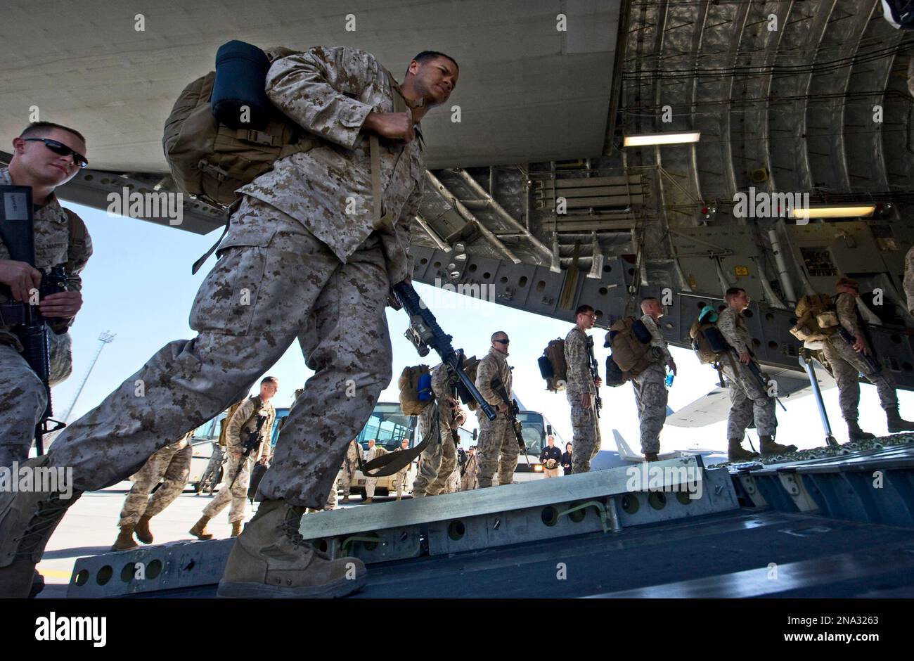 In this Tuesday, March 27, 2012 photo US Marines board a military ...