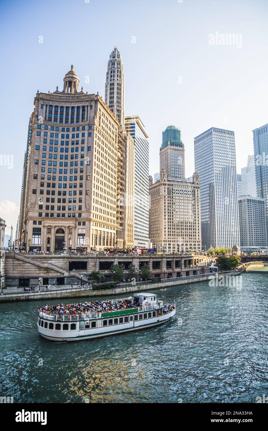 Chicago architecture lining the river with a tour boat; Chicago ...