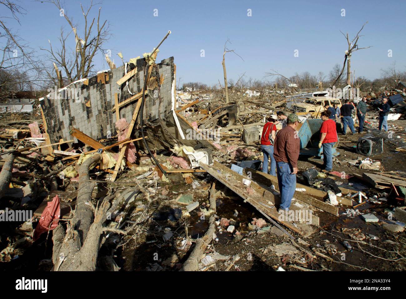 Family members and friends try to salvage what they can after a tornado ...