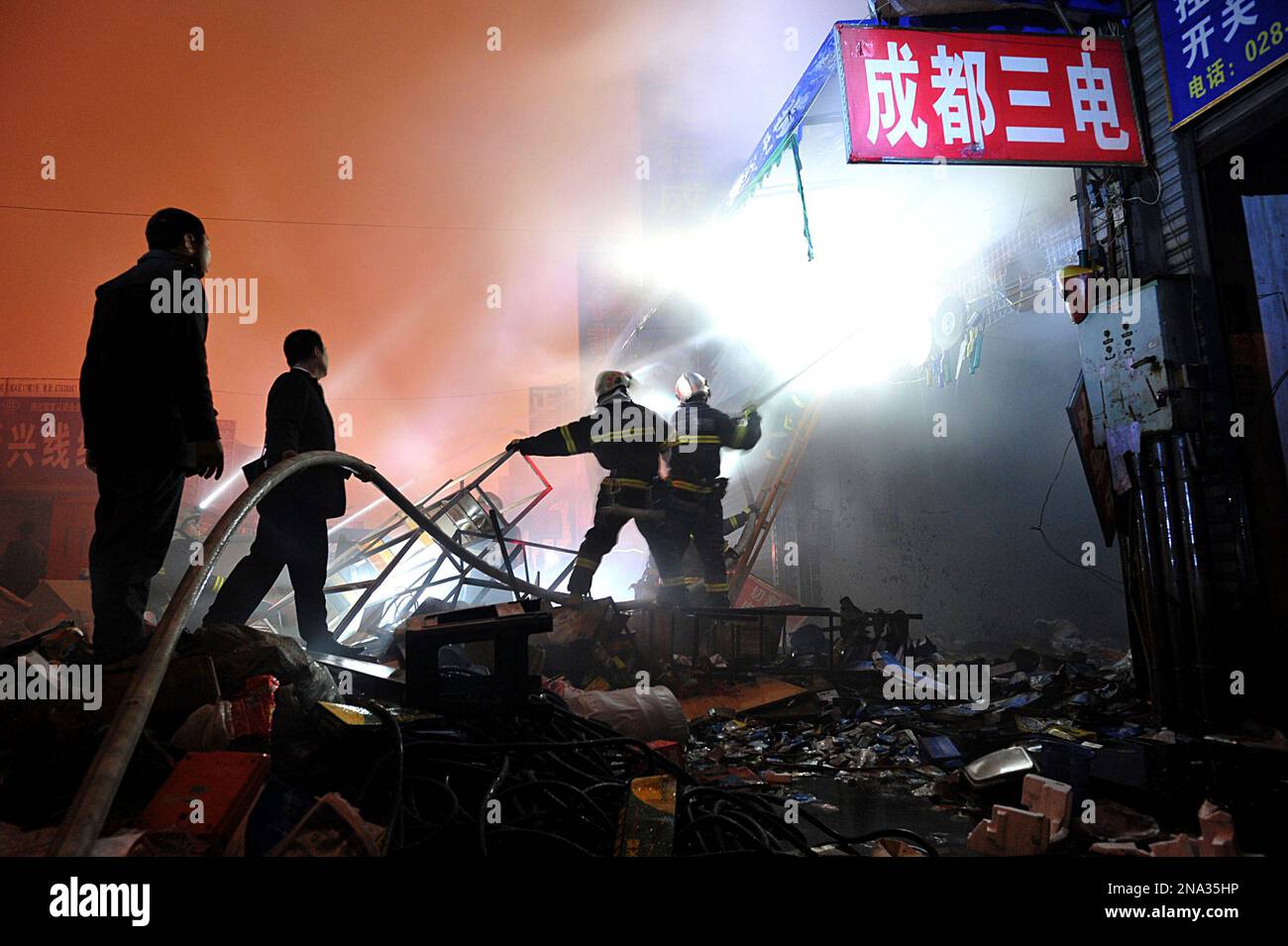 In this photo taken Sunday, March 25, 2012, firefighters attempt to put ...