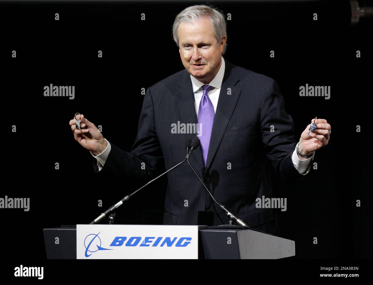 Boeing Commercial Airplanes president and CEO Jim Albaugh, holds up the ...