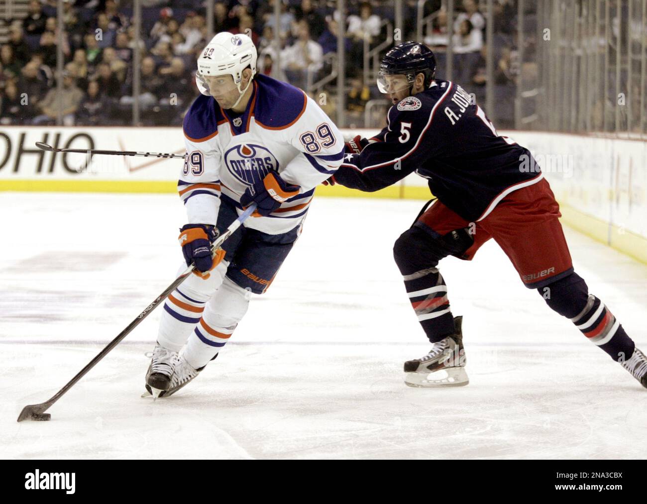 Edmonton Oilers' Sam Gagner, left, controls the puck against Columbus ...