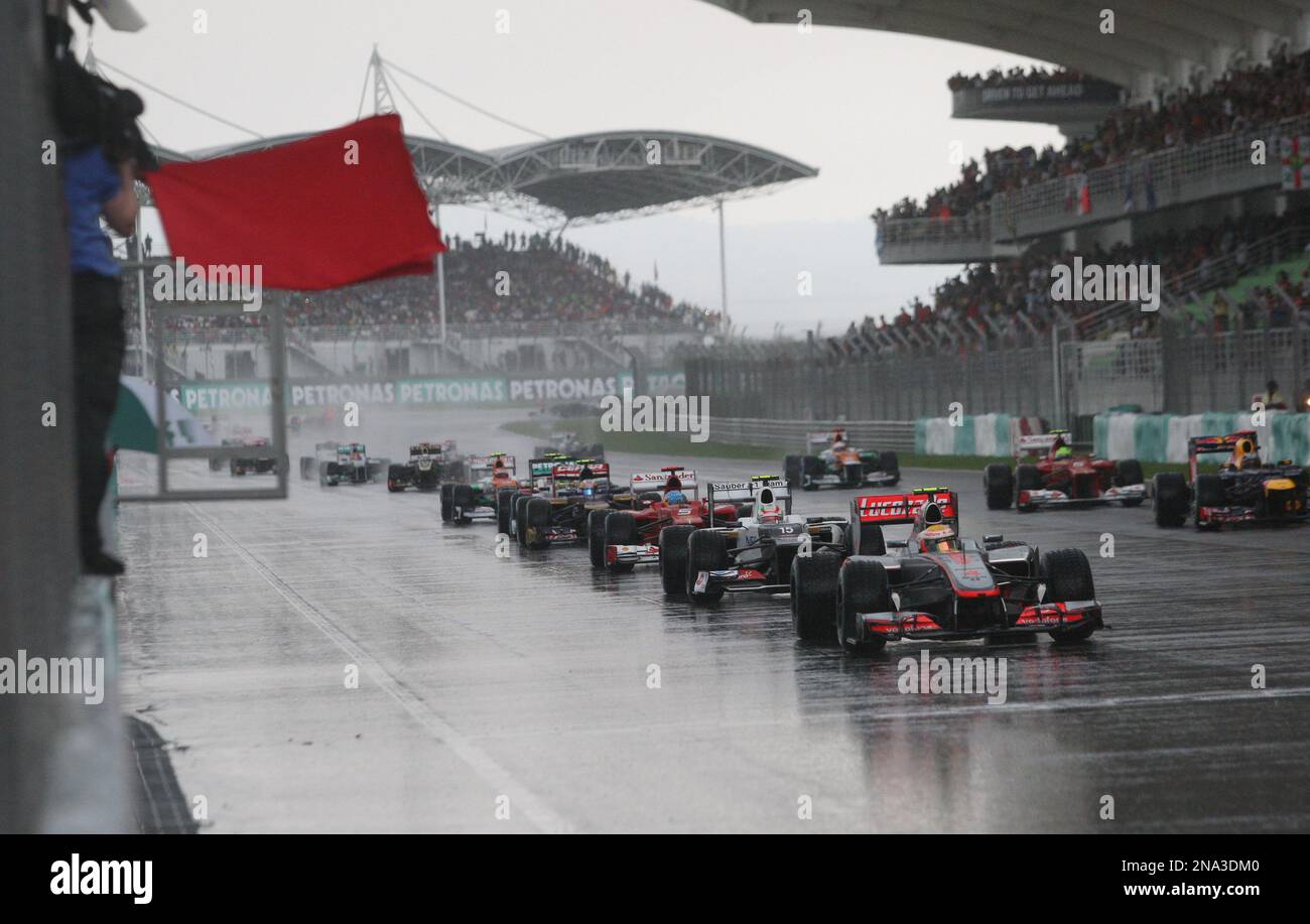 Cars line up on the starting grid as the race is stopped due to the ...