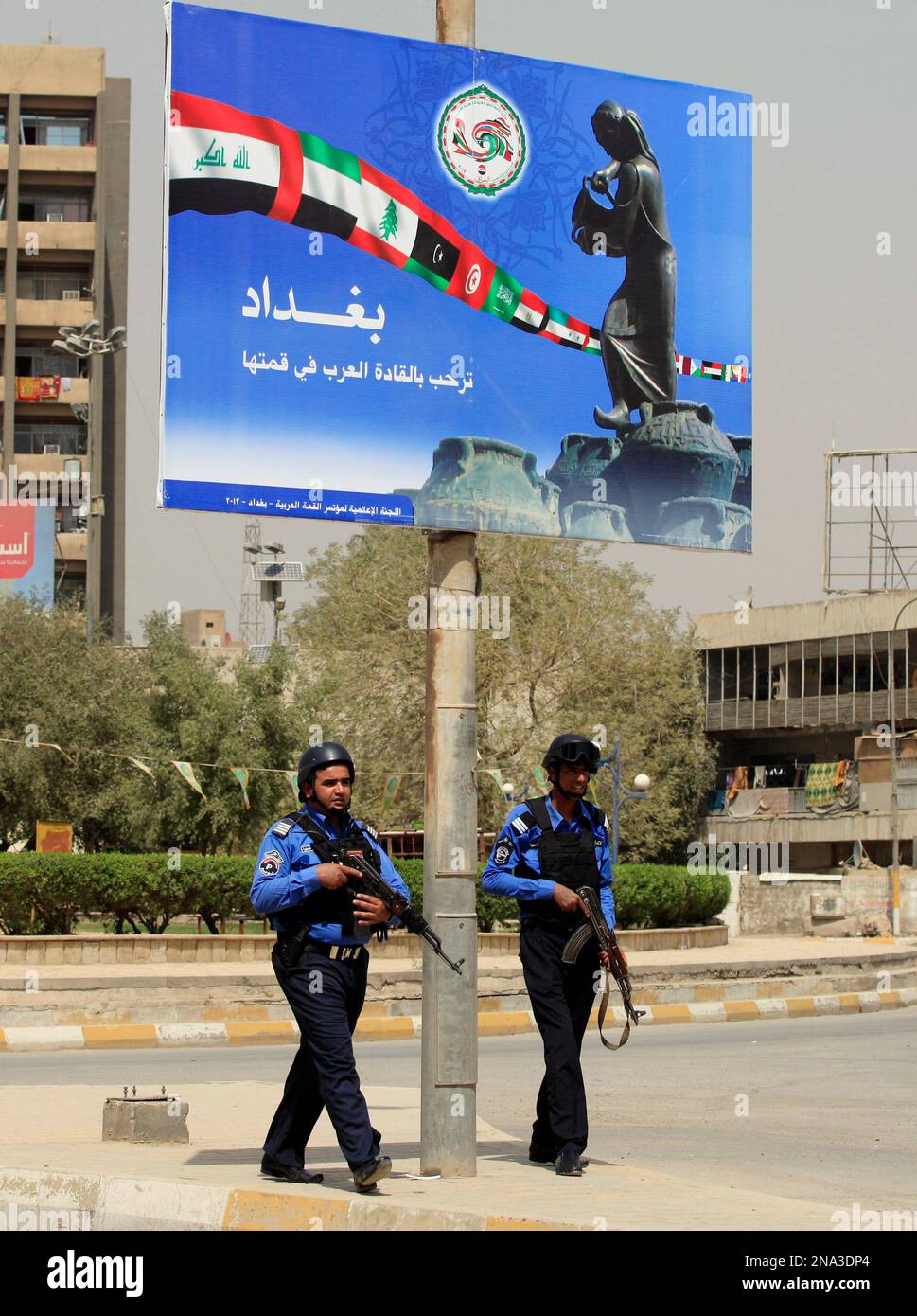 Iraqi police officers stand guard in central Baghdad, Iraq, as the ...