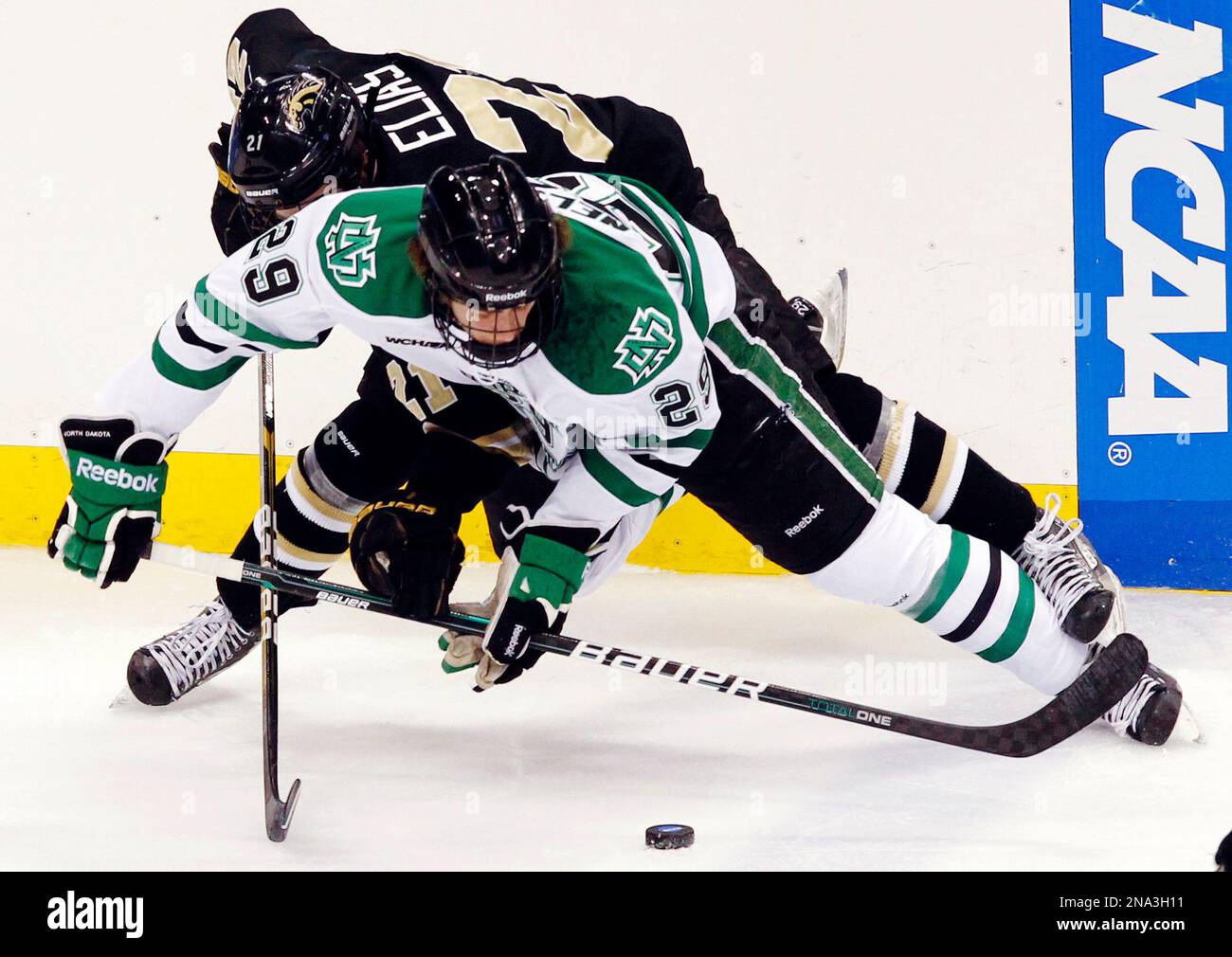 North Dakota's Brock Nelson (29), front, battles for possession against ...