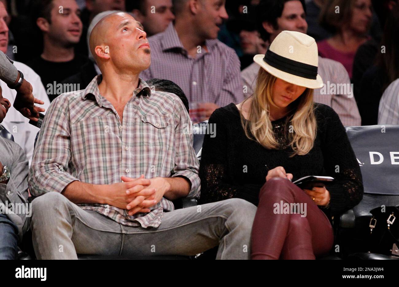 Actress Kaley Cuoco signs for the food service bill next to an ...