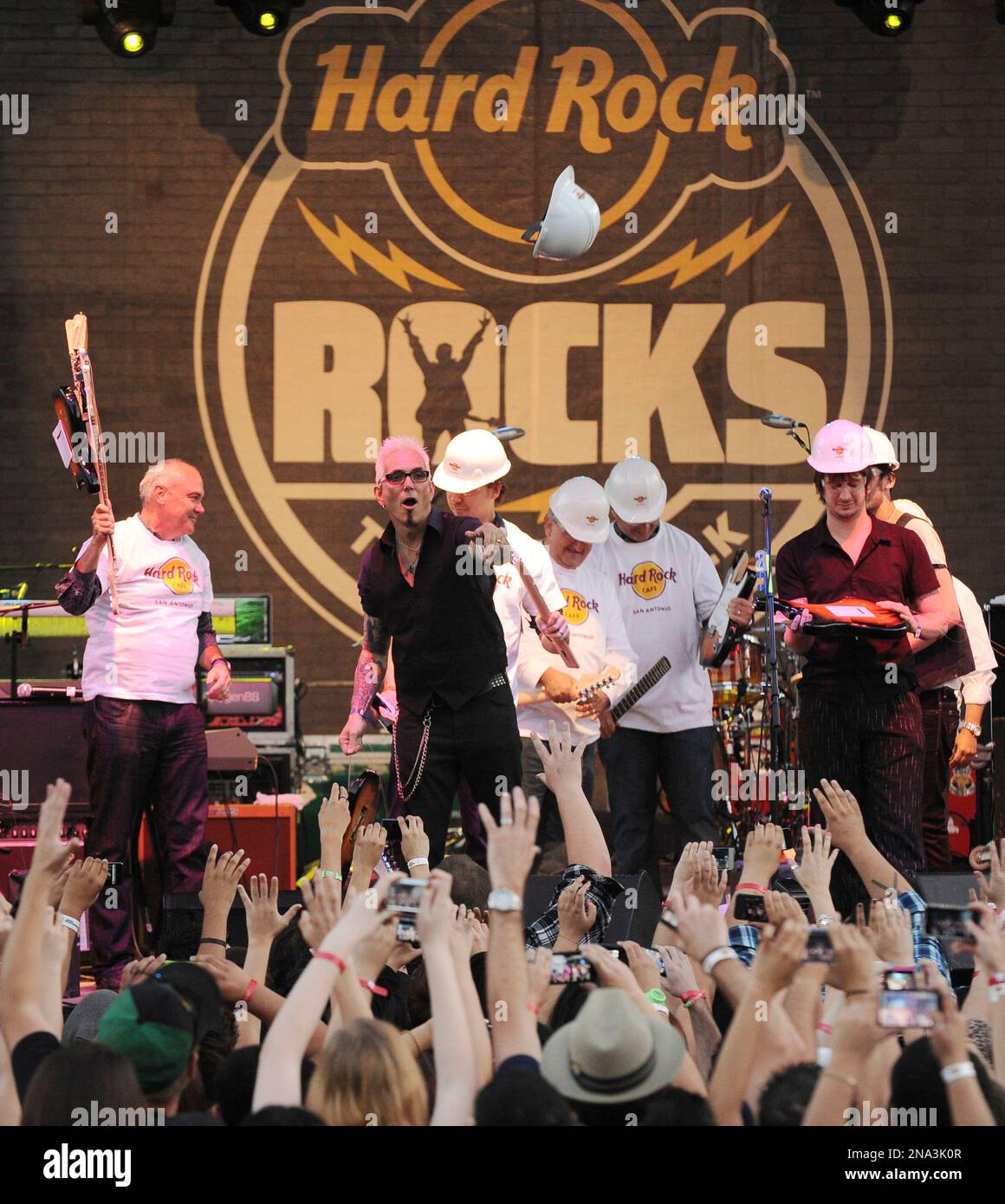 Rock band front man Art Alexakis tosses a hard hat into the crowd ...