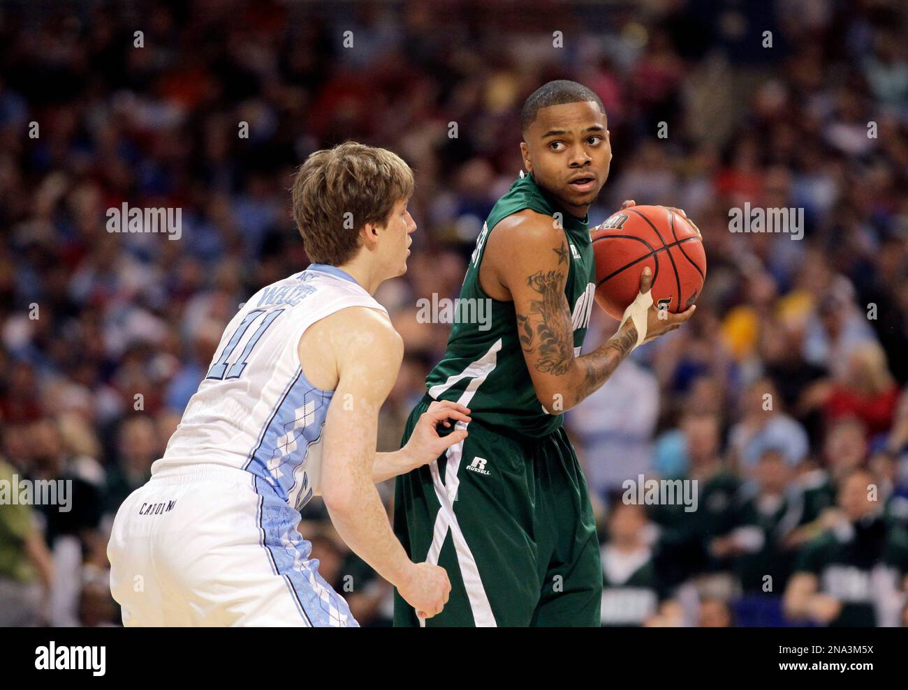 Ohio Bobcats guard D.J. Cooper looks to pass arond North Carolina Tar ...