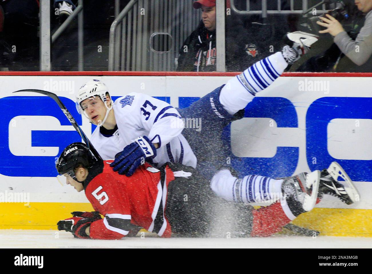 Toronto Maple Leafs' Carter Ashton (37) falls on top of New Jersey ...