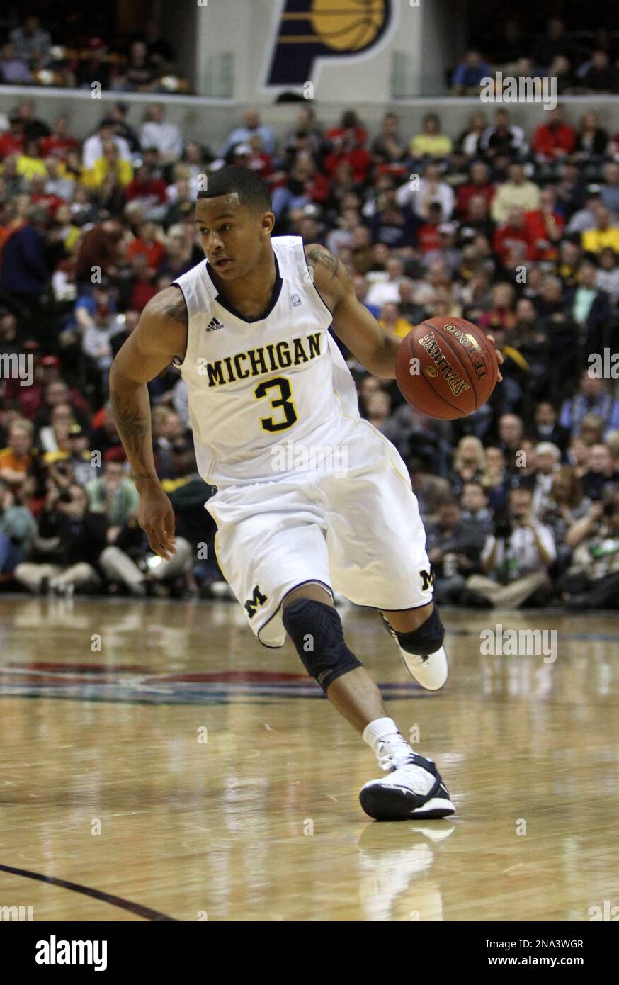 Michigan guard Trey Burke drives in the second half of an NCAA college ...