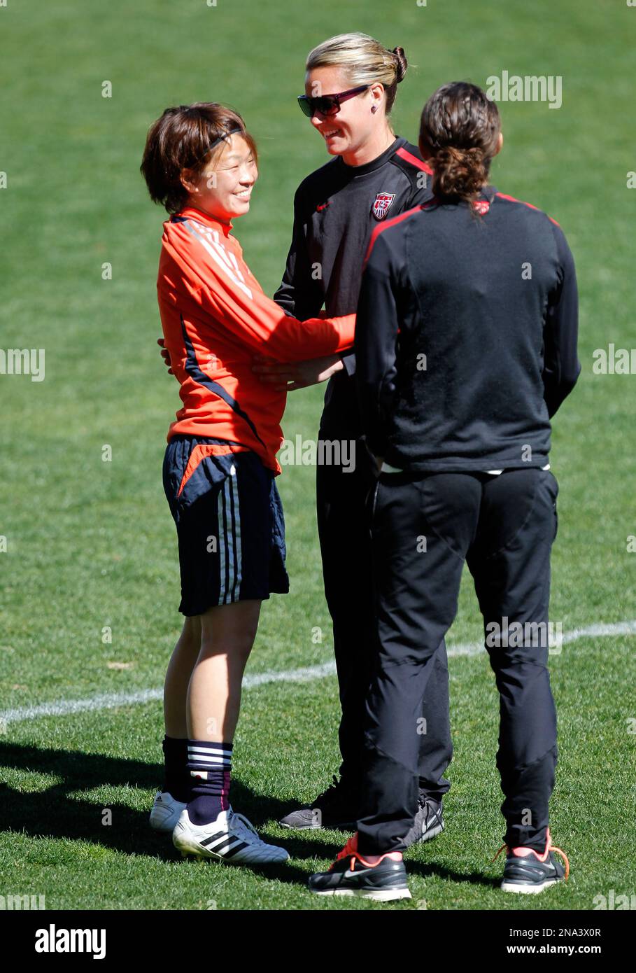 Japan's team captain Aya Miyama, left, chats with players of the United ...