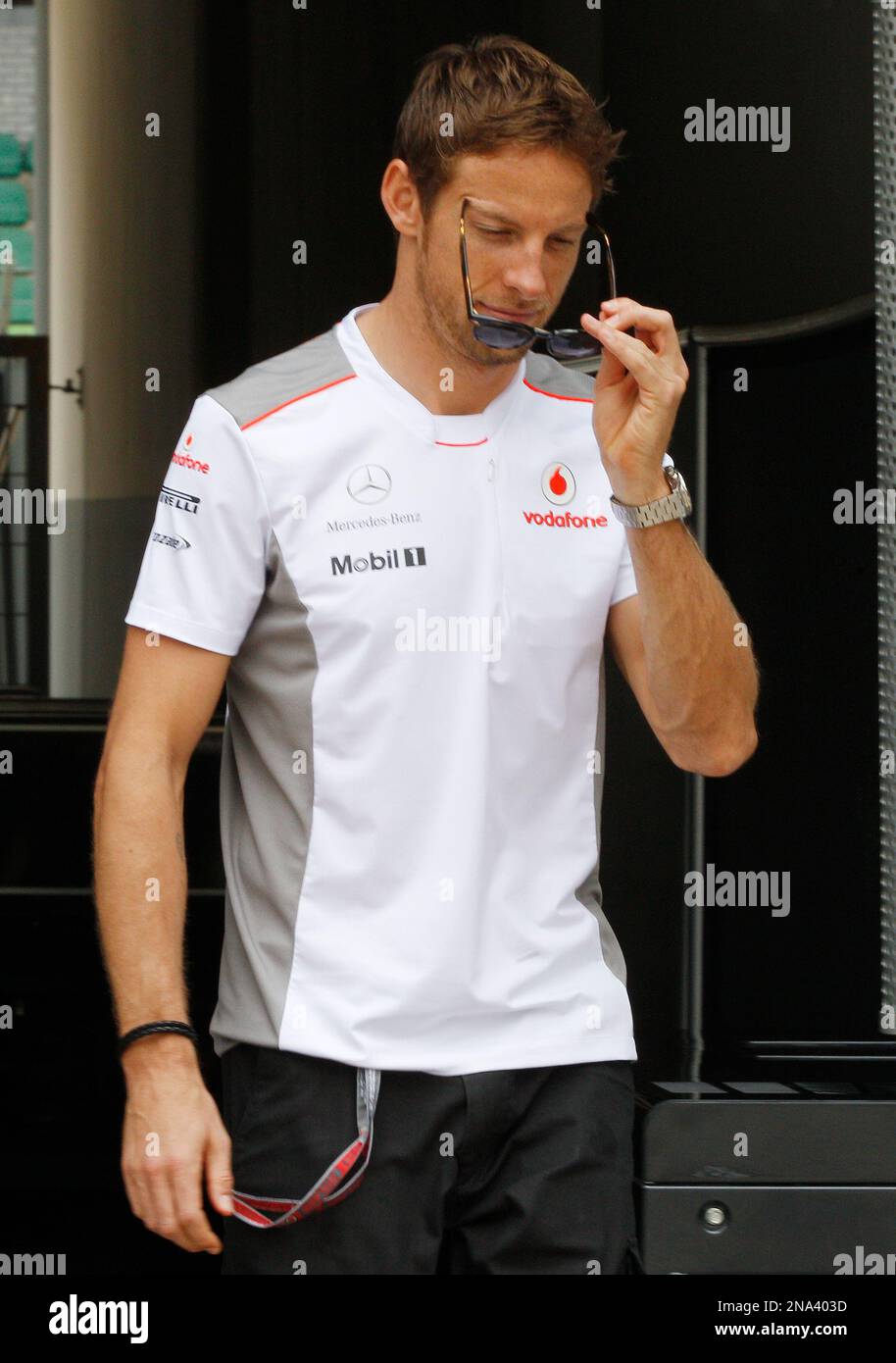 McLaren Formula One driver Jenson Button of Britain walks in the F1 ...