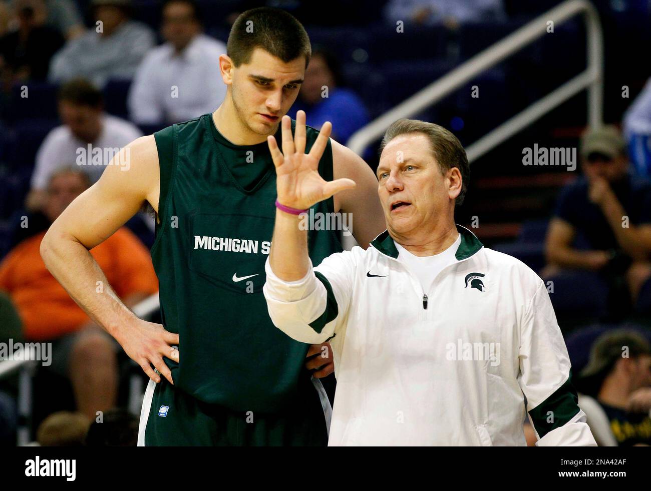 Michigan State head coach Tom Izzo talks with forward Alex Gauna during ...