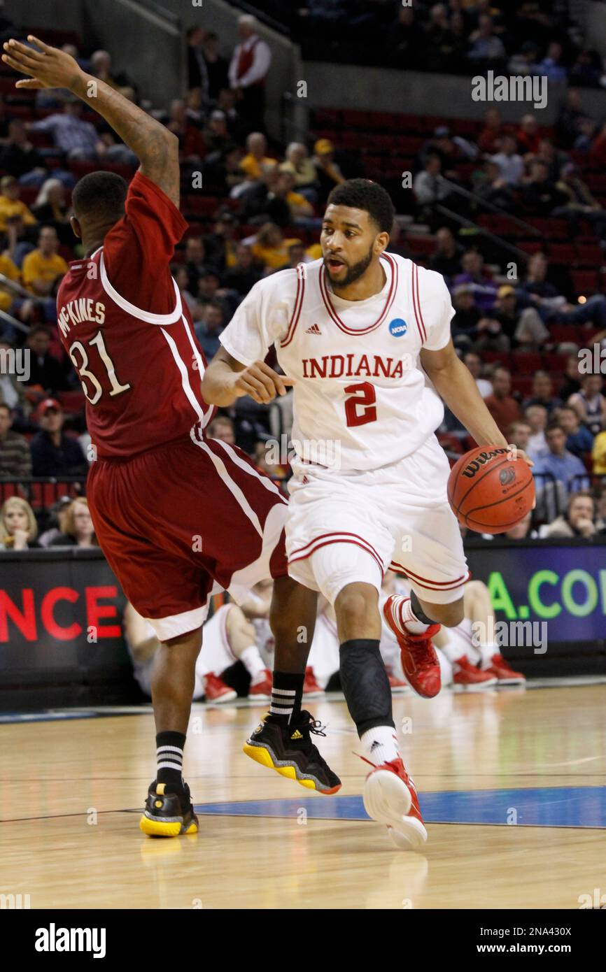Indiana forward Christian Watford, right, drives on New Mexico State ...