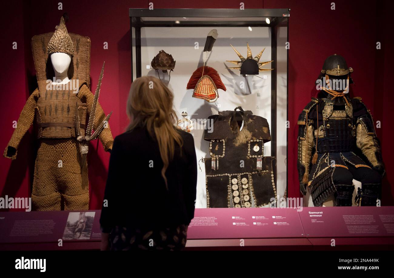 A member of public views Warriors armour and Samurai armour, part of ...
