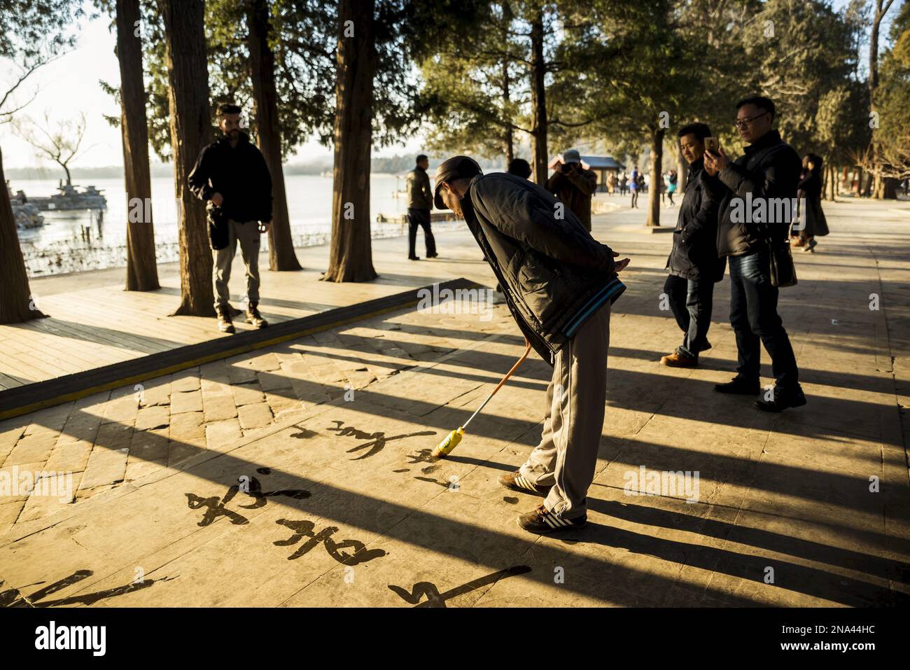 Man writing oversized calligraphy on the floor, The Summer Palace ...