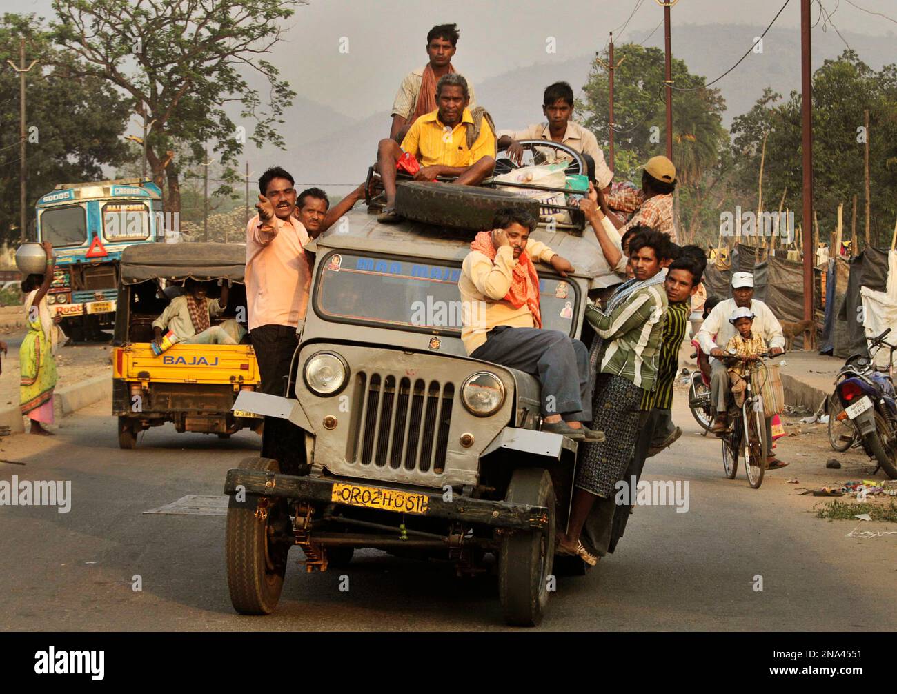 In this Tuesday, March 20, 2012 photo, Indian villagers ride on a ...