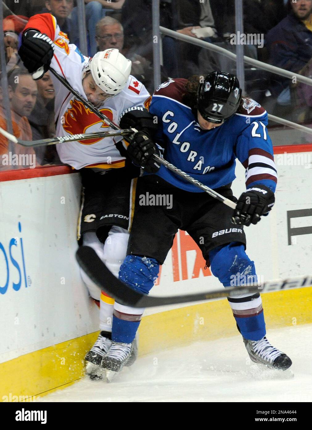 Colorado Avalanche right wing Steve Downie (27) checks Calgary Flames ...