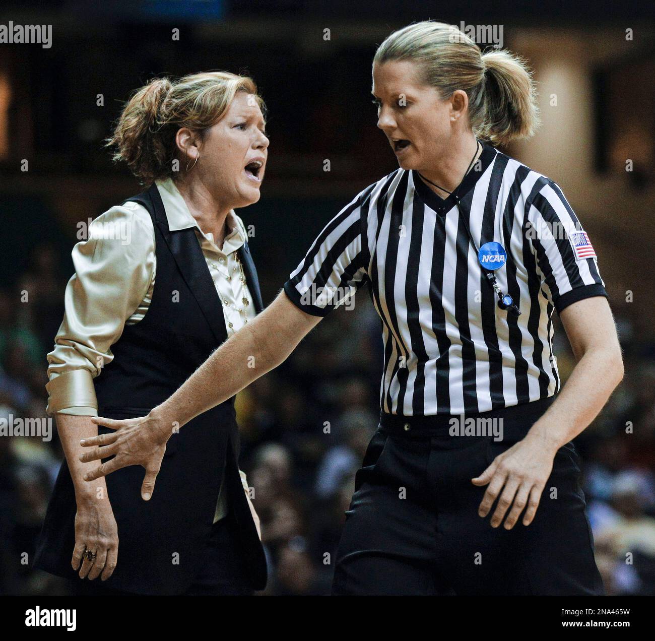Vanderbilt head coach Melanie Balcomb, left, is restrained by an ...