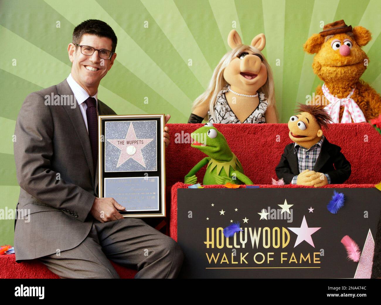 Walt Disney Studios Chairman, Rich Ross poses with Muppets characters ...